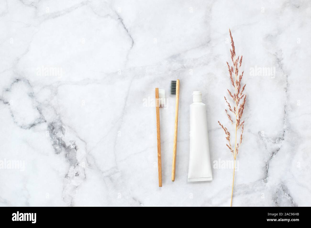 Set of eco-friendly toothbrushes and toothpaste on marble background ...
