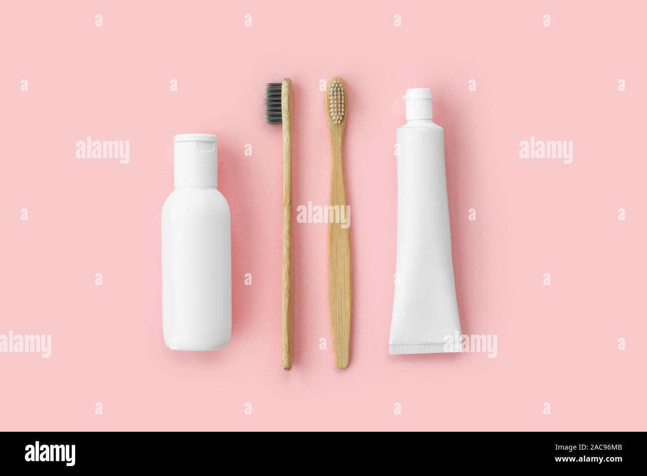 Set of eco-friendly toothbrushes, toothpaste and other tools on pink ...