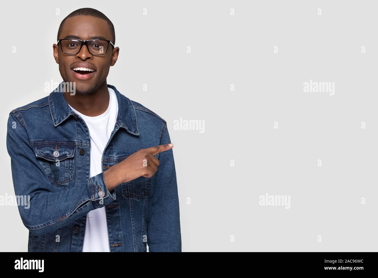 Happy African American man pointing finger at copy space Stock Photo ...