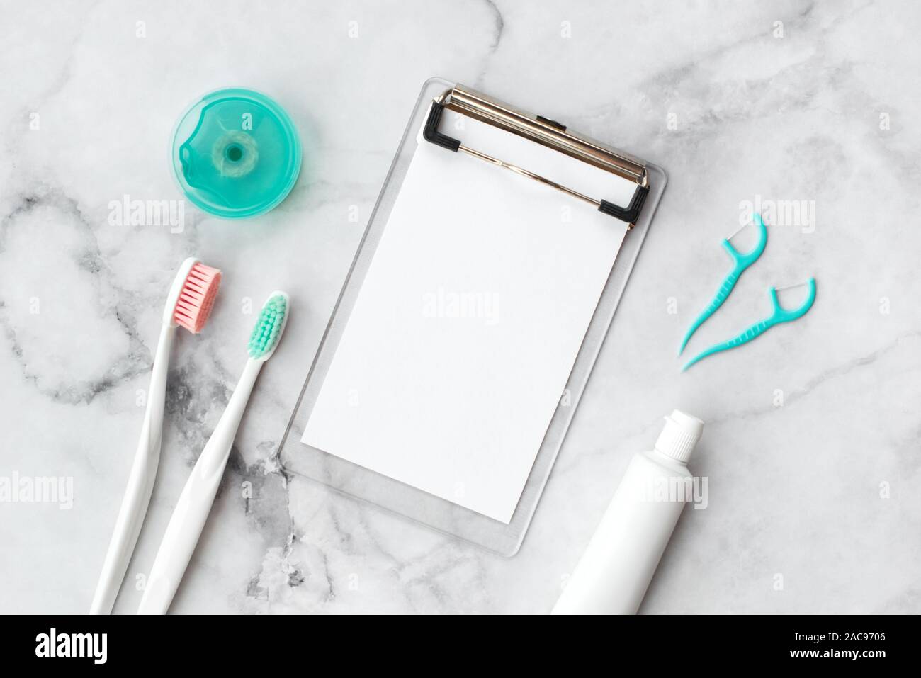 Set of pink and turquoise blue toothbrushes, toothpaste and other tools ...