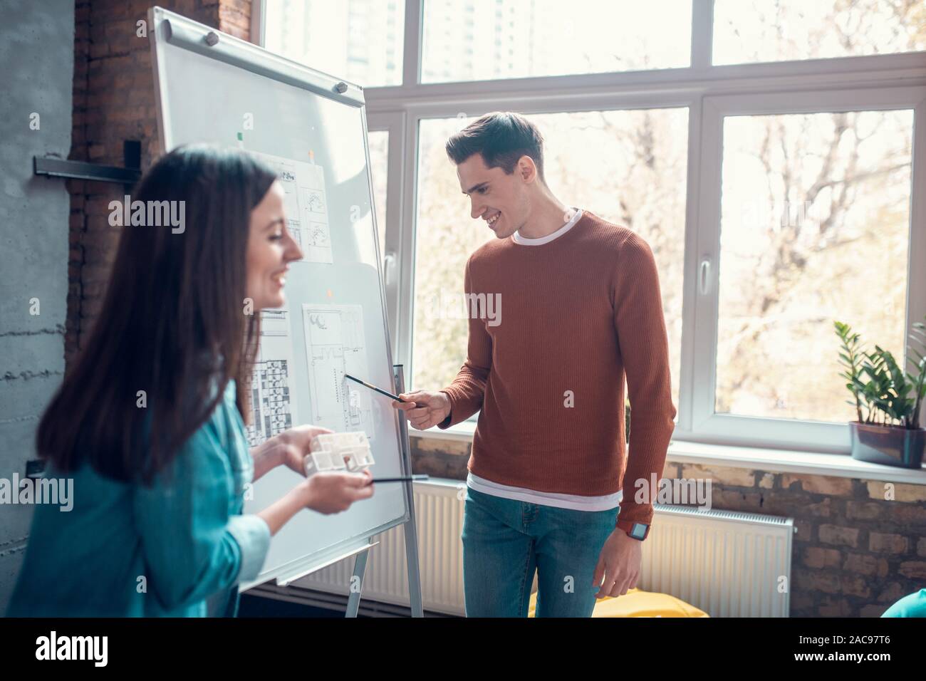 Positive people presenting new hi-res stock photography and images - Alamy