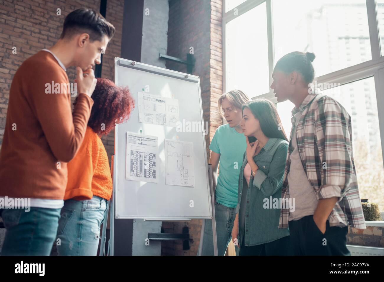 Student talking. Dark-haired student wearing denim shirt talking while ...