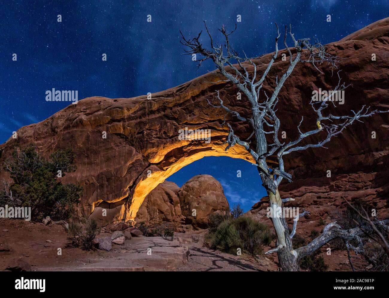A warm light highlights the North WIndow natural arch in the Windows ...