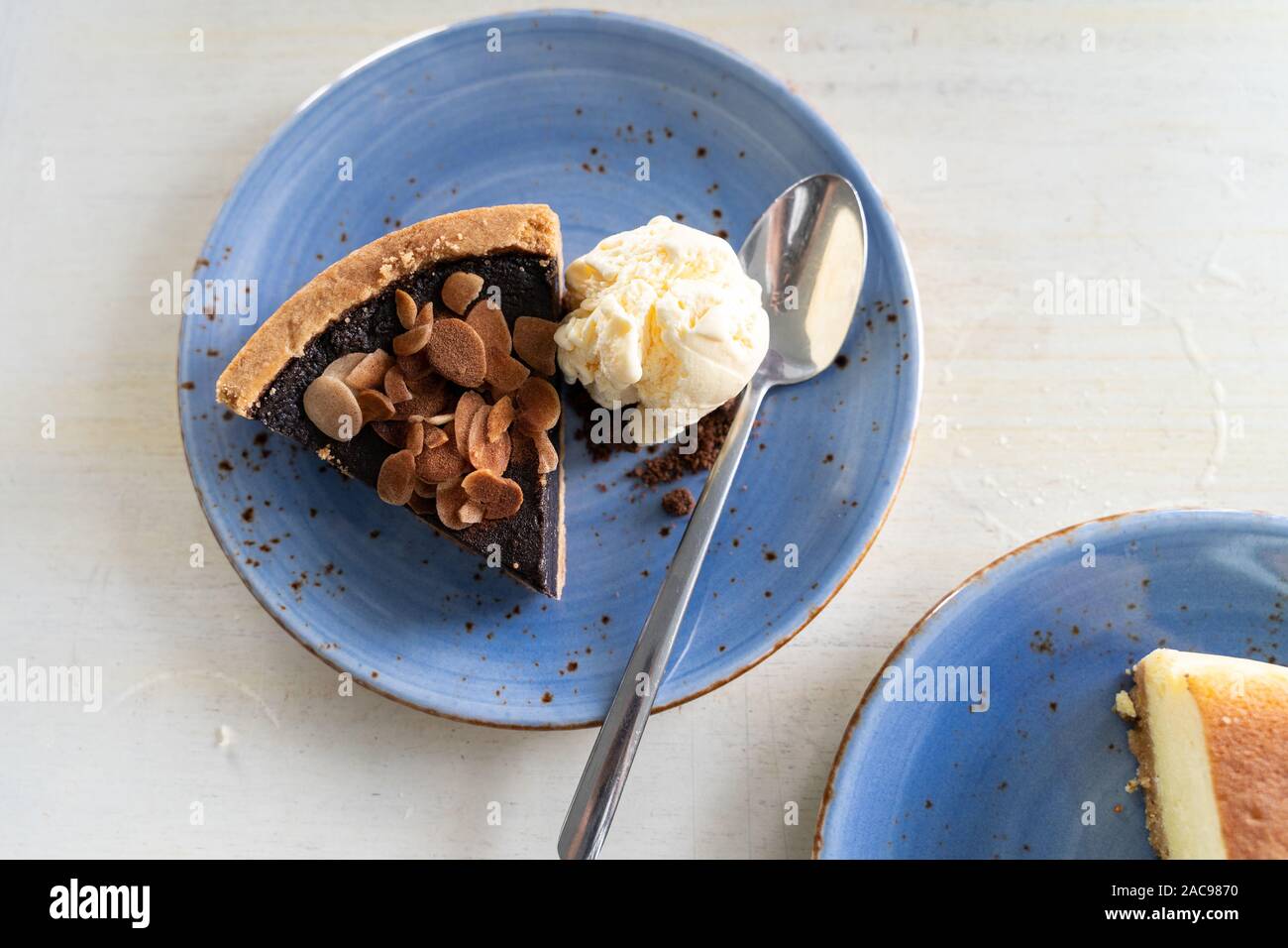 Overhead flatlay view of a slice of chocolate pecan pie with vanilla ...