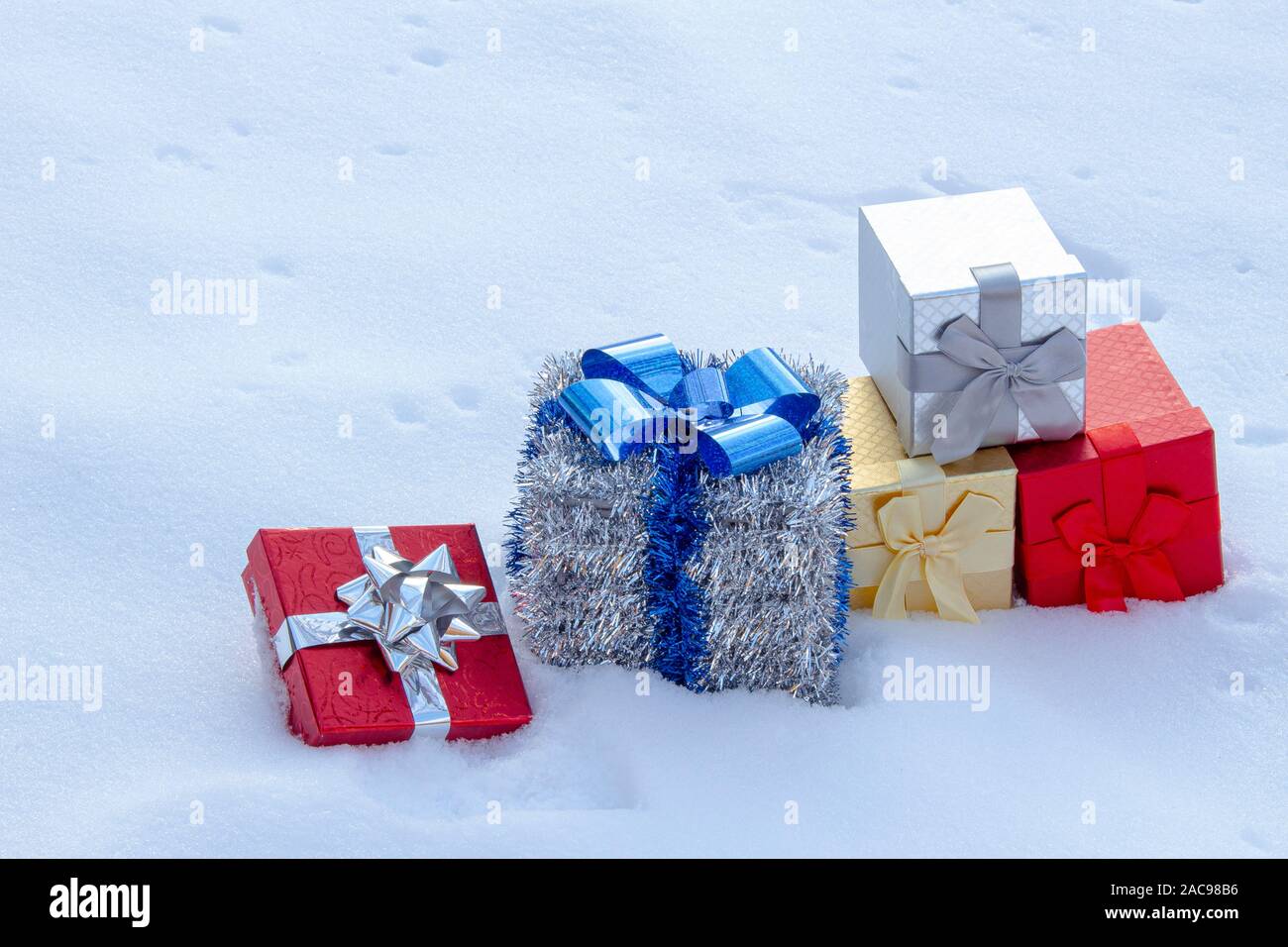 Colourful Gif boxes Presents on snow stock on each other Stock Photo ...
