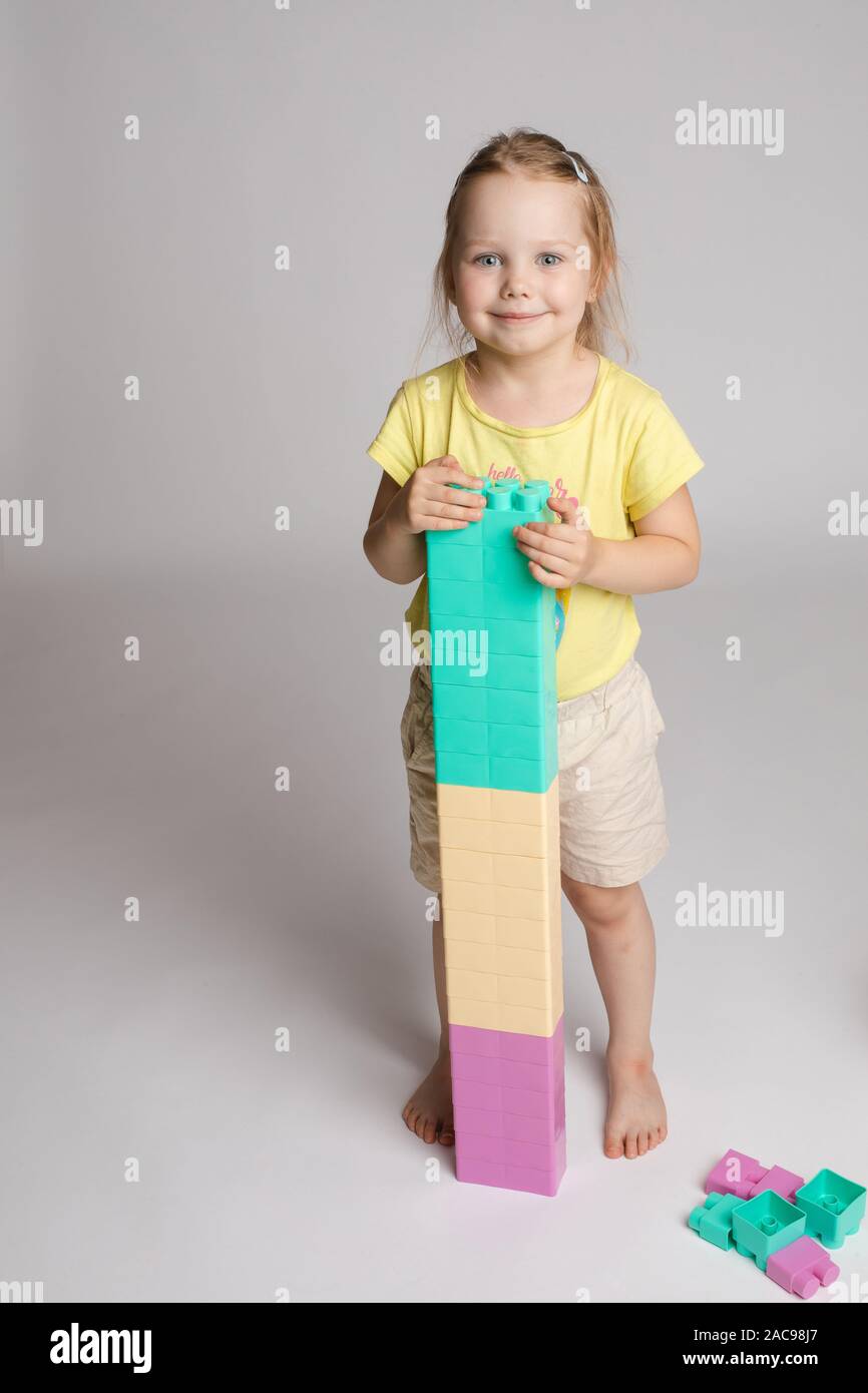 Adorable little kid playing with colorful blocks Stock Photo - Alamy