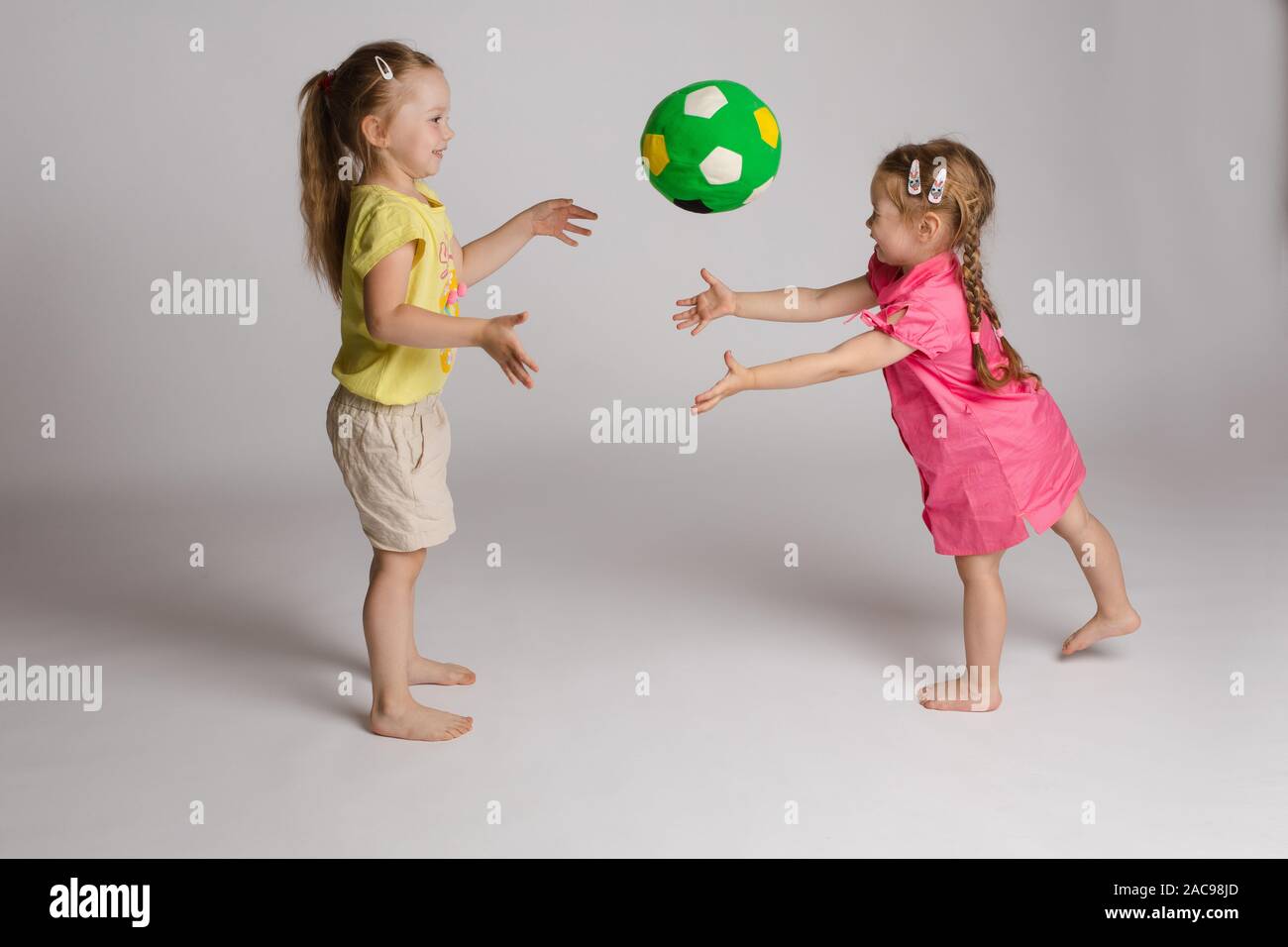 Children throwing ball together hi-res stock photography and images - Alamy