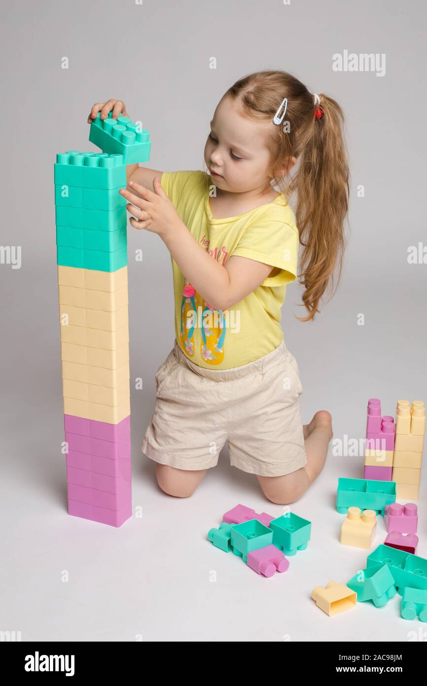 Adorable little kid playing with colorful blocks Stock Photo - Alamy