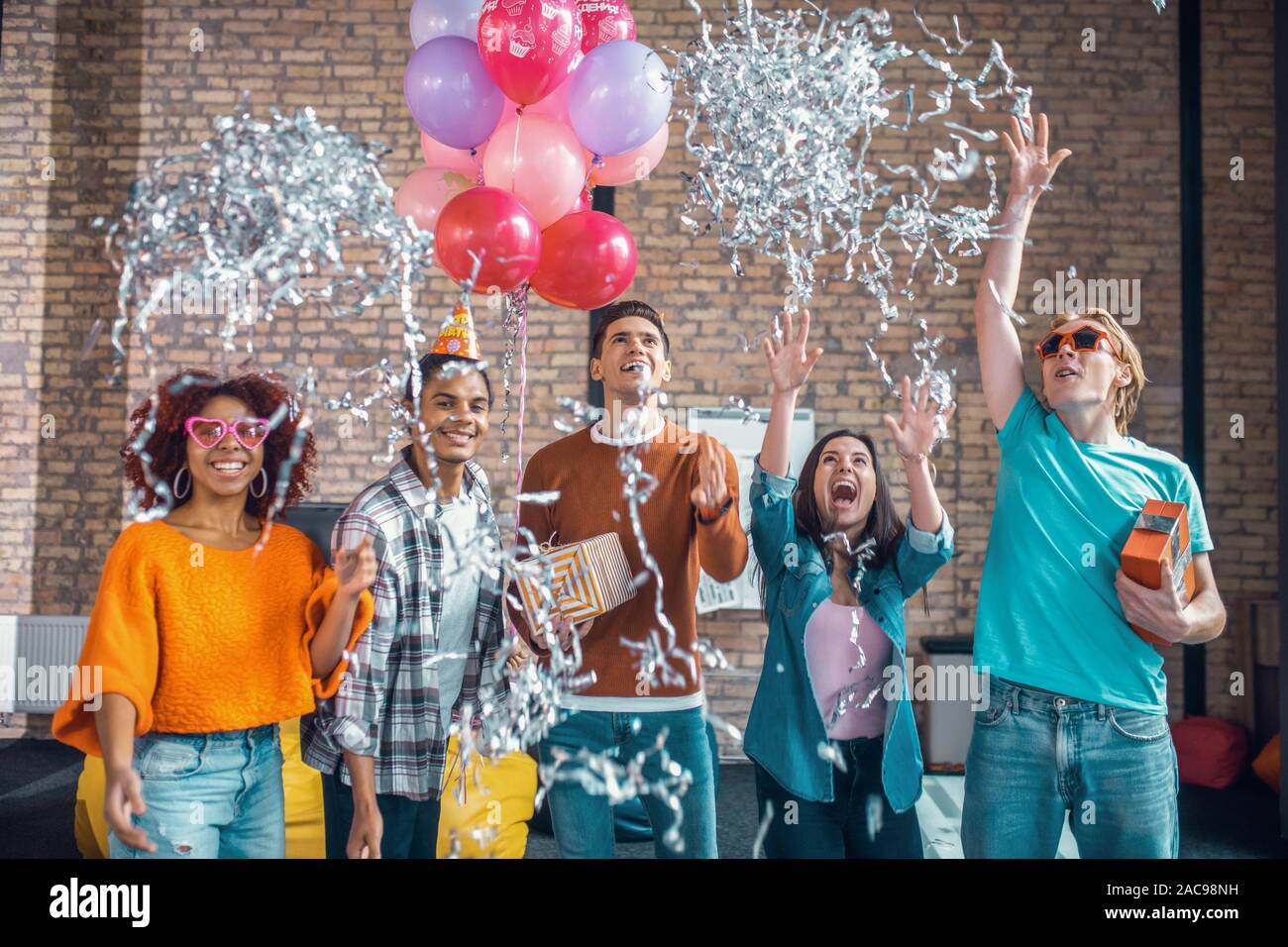 Having much fun. Laughing cheerful students having much fun while ...