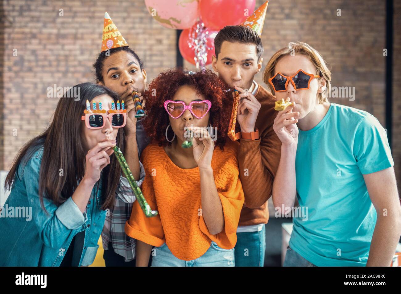 Nice birthday party. Cheerful students enjoying their time while having ...