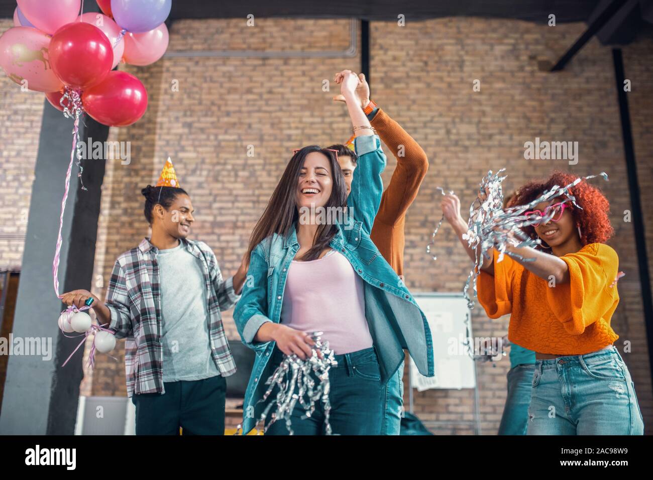 Dancing with boyfriend. Beautiful birthday girl laughing while dancing ...