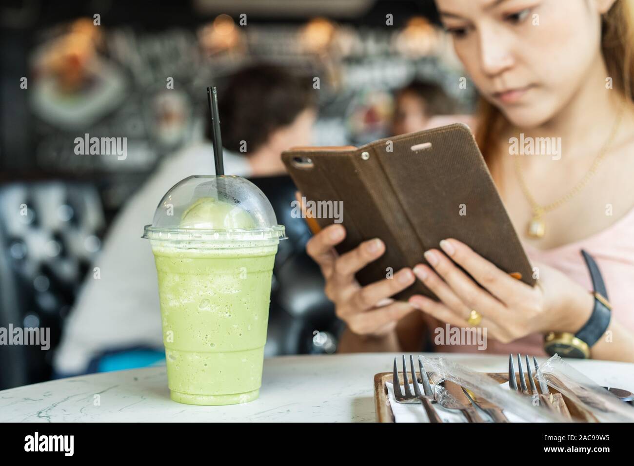 Woman drinking green tea frappe hi-res stock photography and images - Alamy