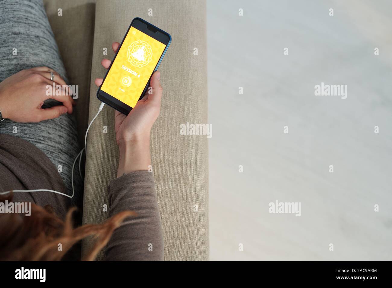 Overview of human hand holding smartphone while going to watch video ...