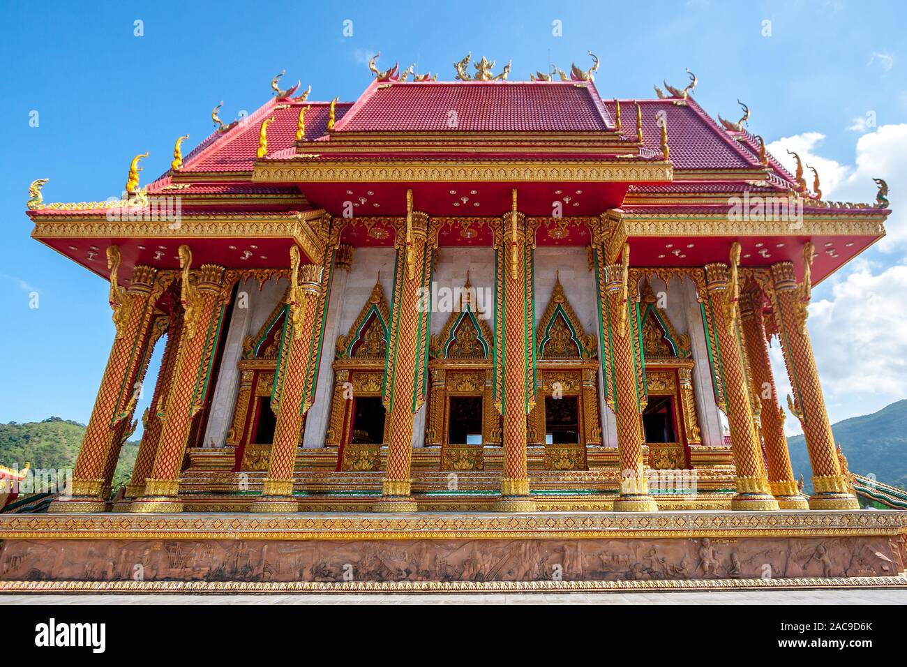 A beautiful Buddhist temple with gilded columns and an ornament and a ...