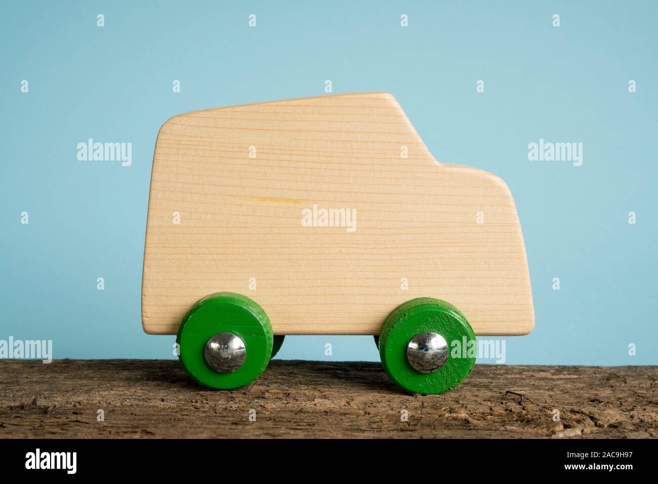 Handmade wooden toy car on a light blue background Stock Photo - Alamy