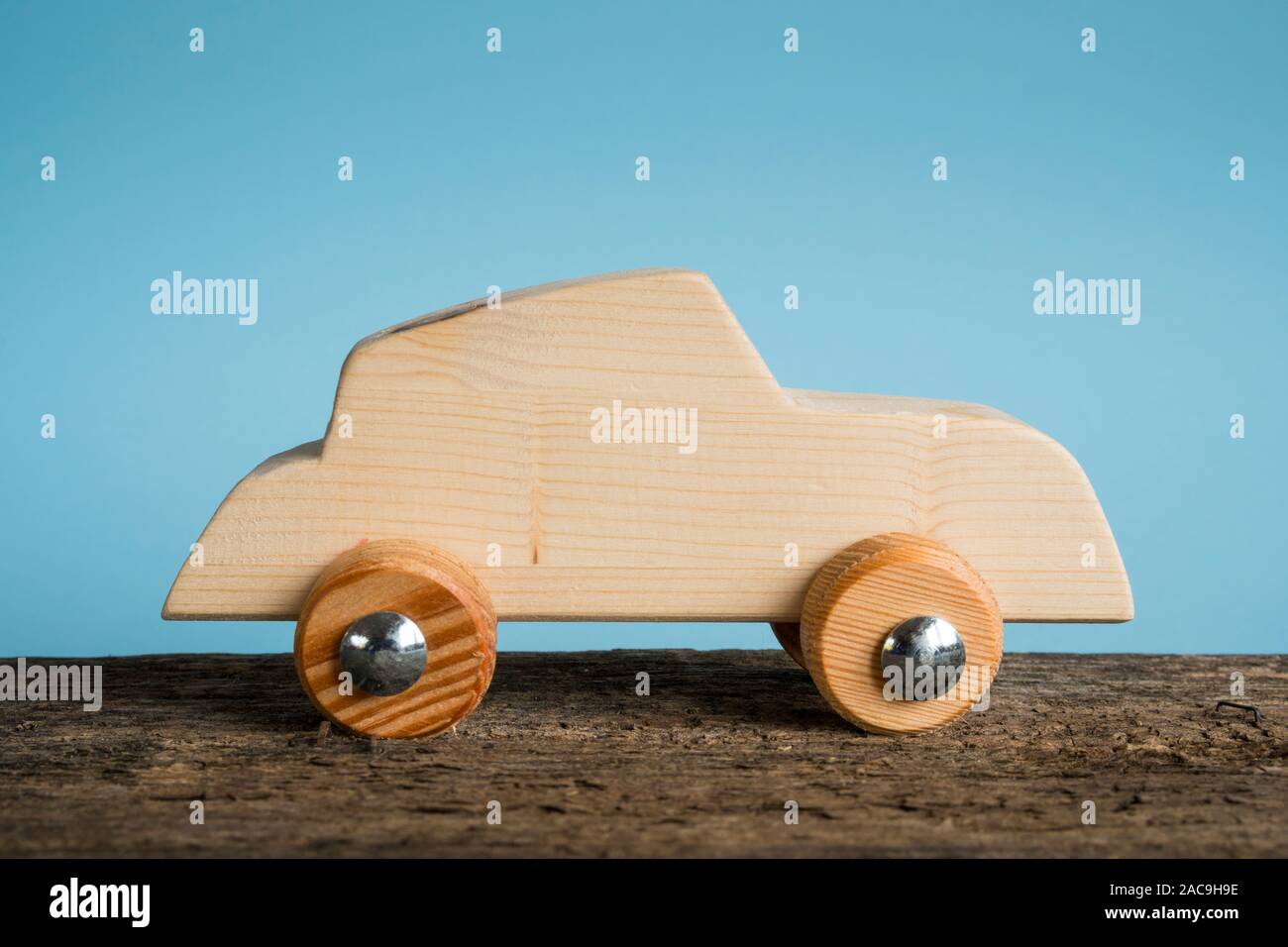 Handmade wooden toy car on a light blue background Stock Photo - Alamy