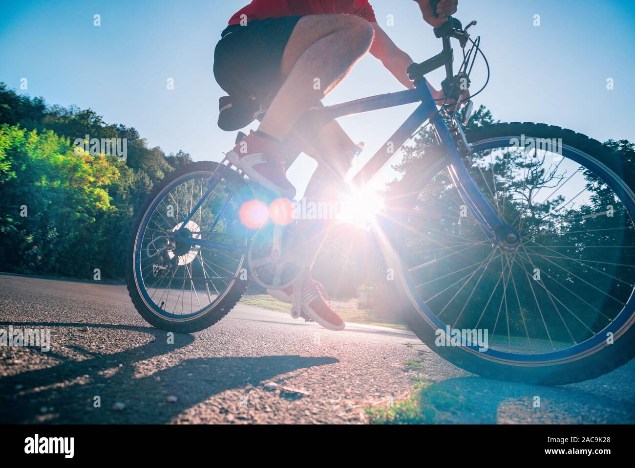 Fit male biker cyclist riding his bike cycle on an asphalt road at ...