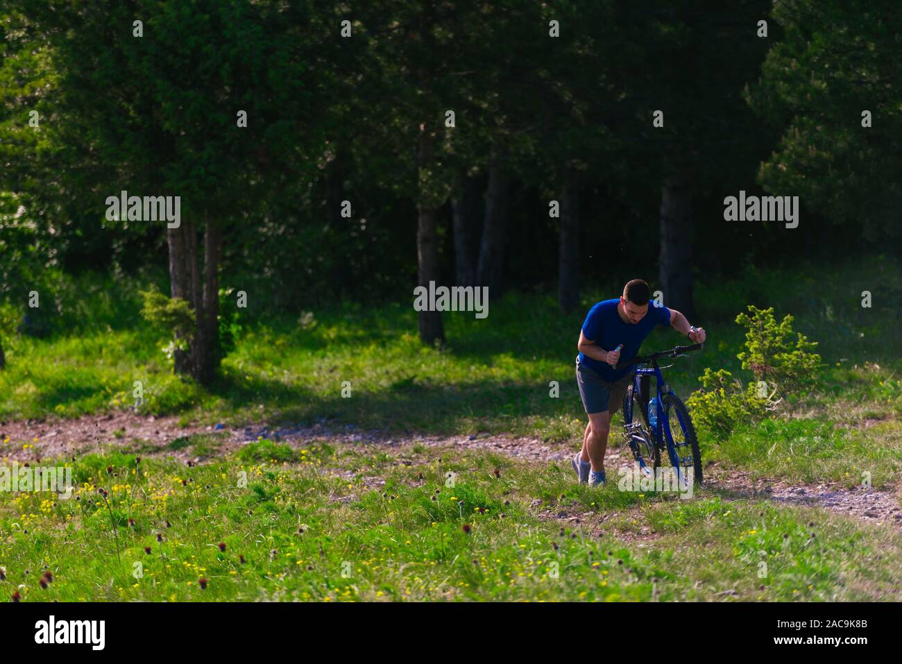 Downhill rider pushing bike hi-res stock photography and images - Alamy