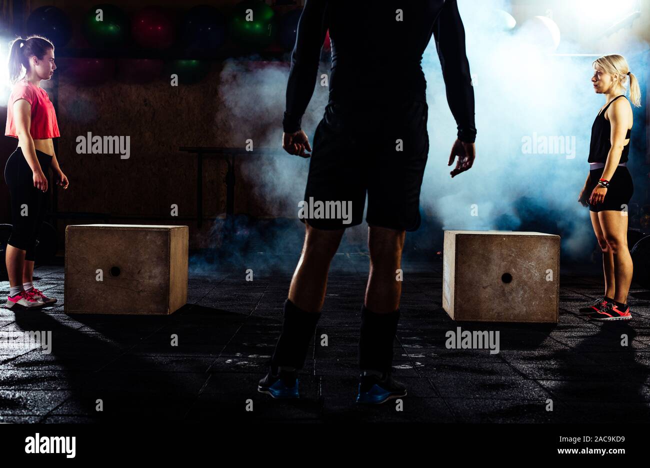 Crossfit class jumping on wooden boxes guided by trainer Stock Photo ...