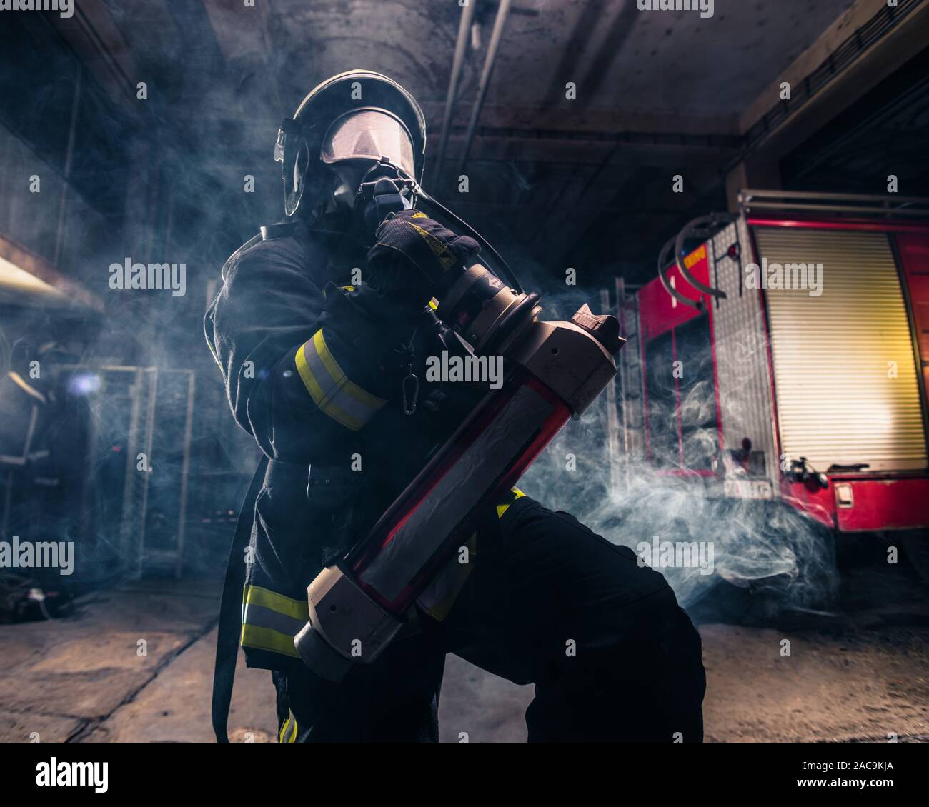 Portrait of a female firefighter wearing a helmet and all safety ...