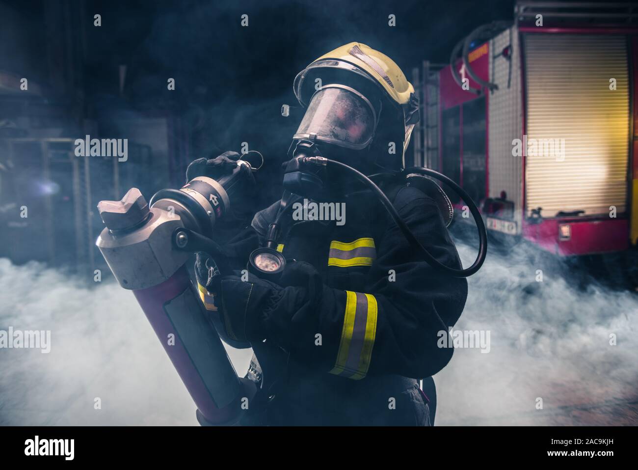 Portrait of a female firefighter wearing a helmet and all safety ...