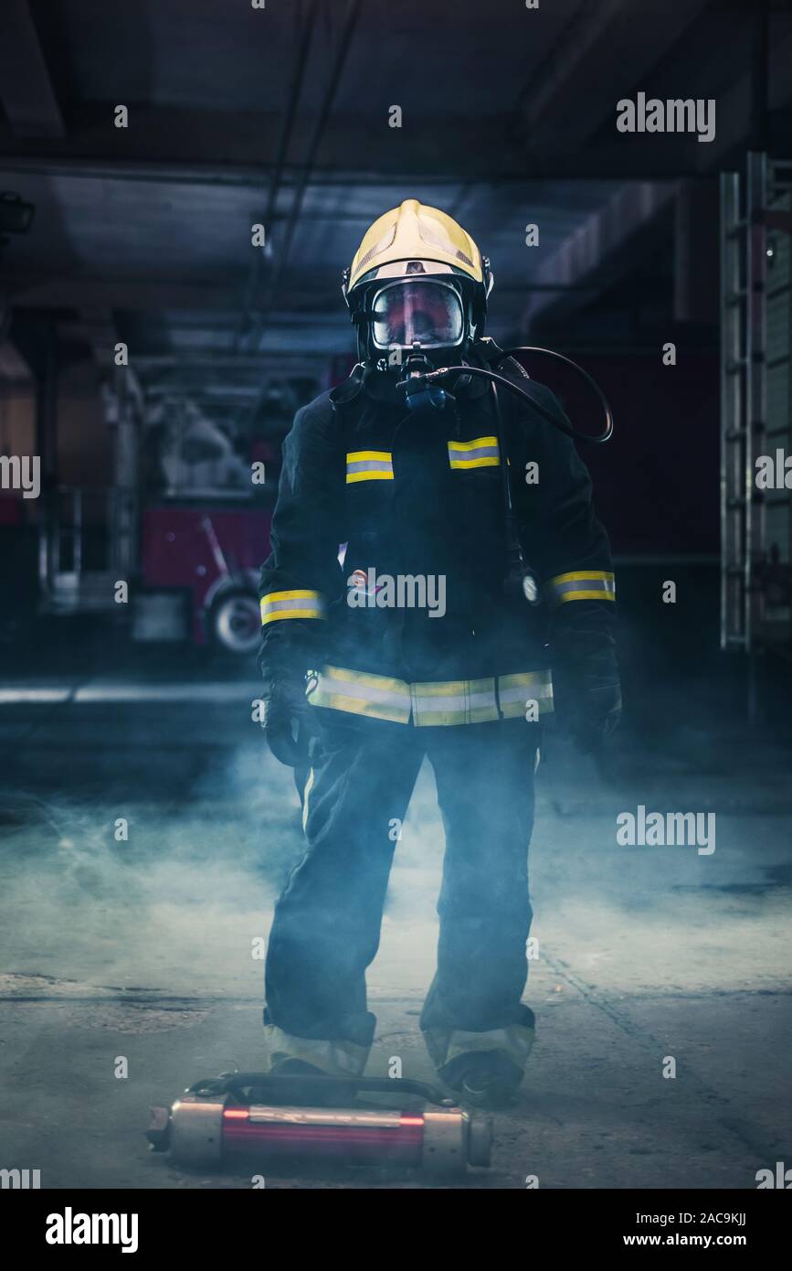 Portrait of a female firefighter wearing a helmet and all safety ...