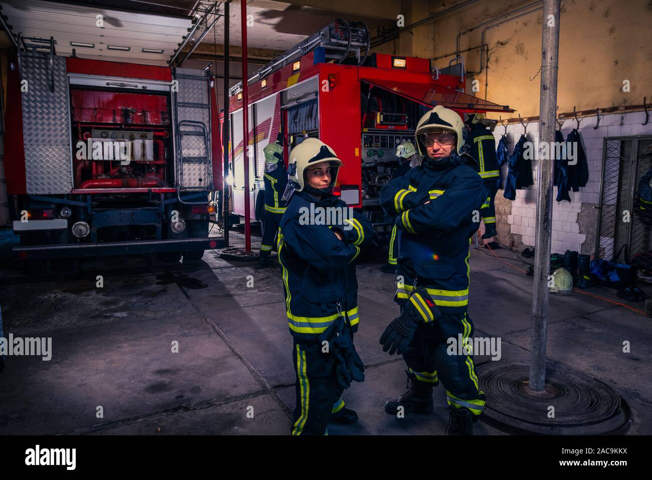 Firefighters preparing their uniform and the firetruck in the ...