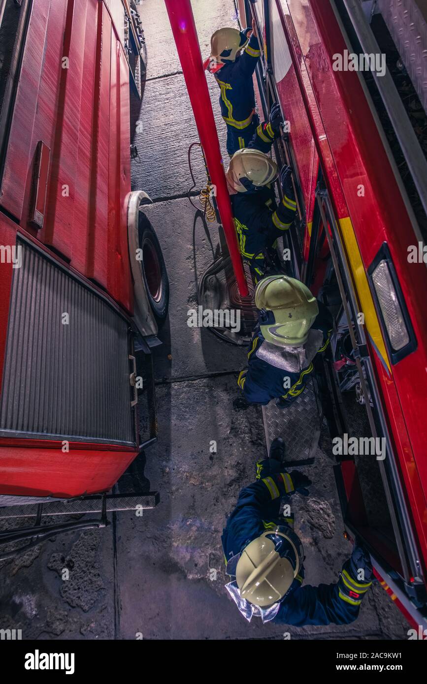 Firemen checking the fire engine inside the fire department from a bird ...