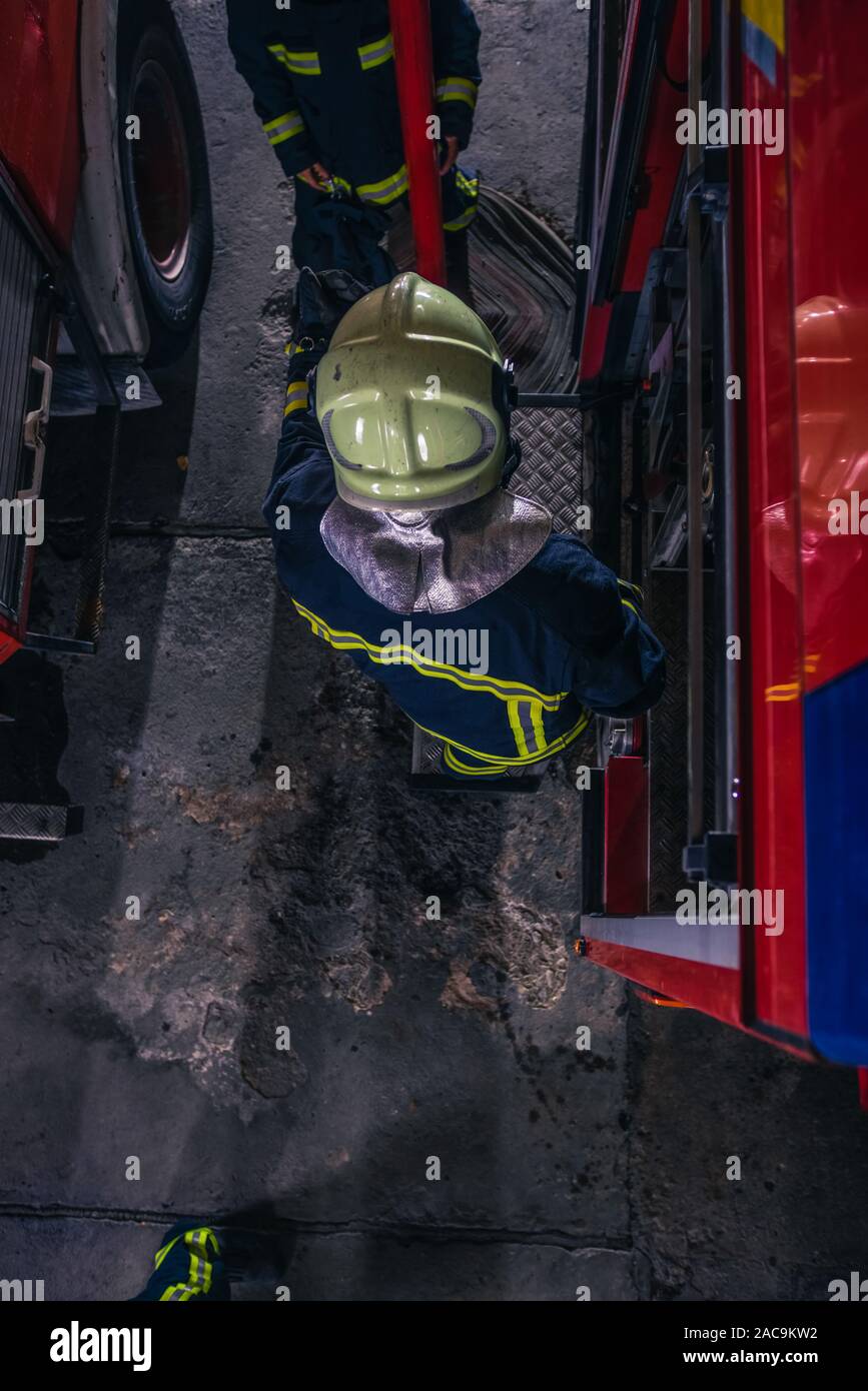 Firemen checking the fire engine inside the fire department from a bird ...