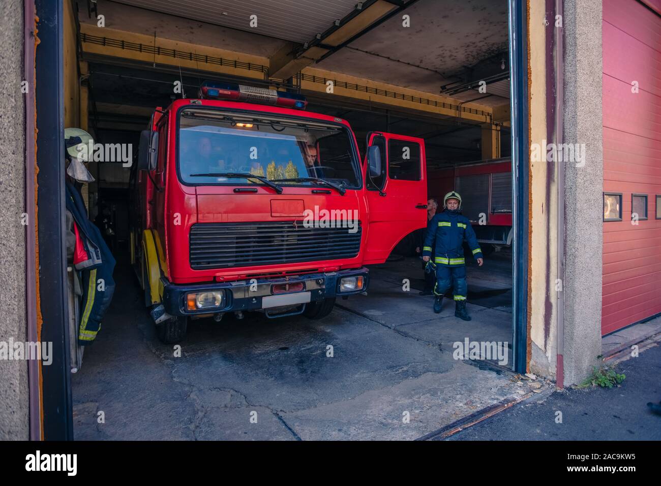 Fire engine inside the garage of the fire department Stock Photo - Alamy