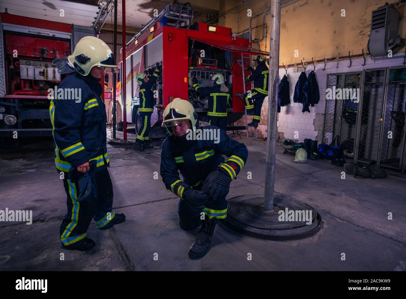 Firefighters preparing their uniform and the firetruck in the ...