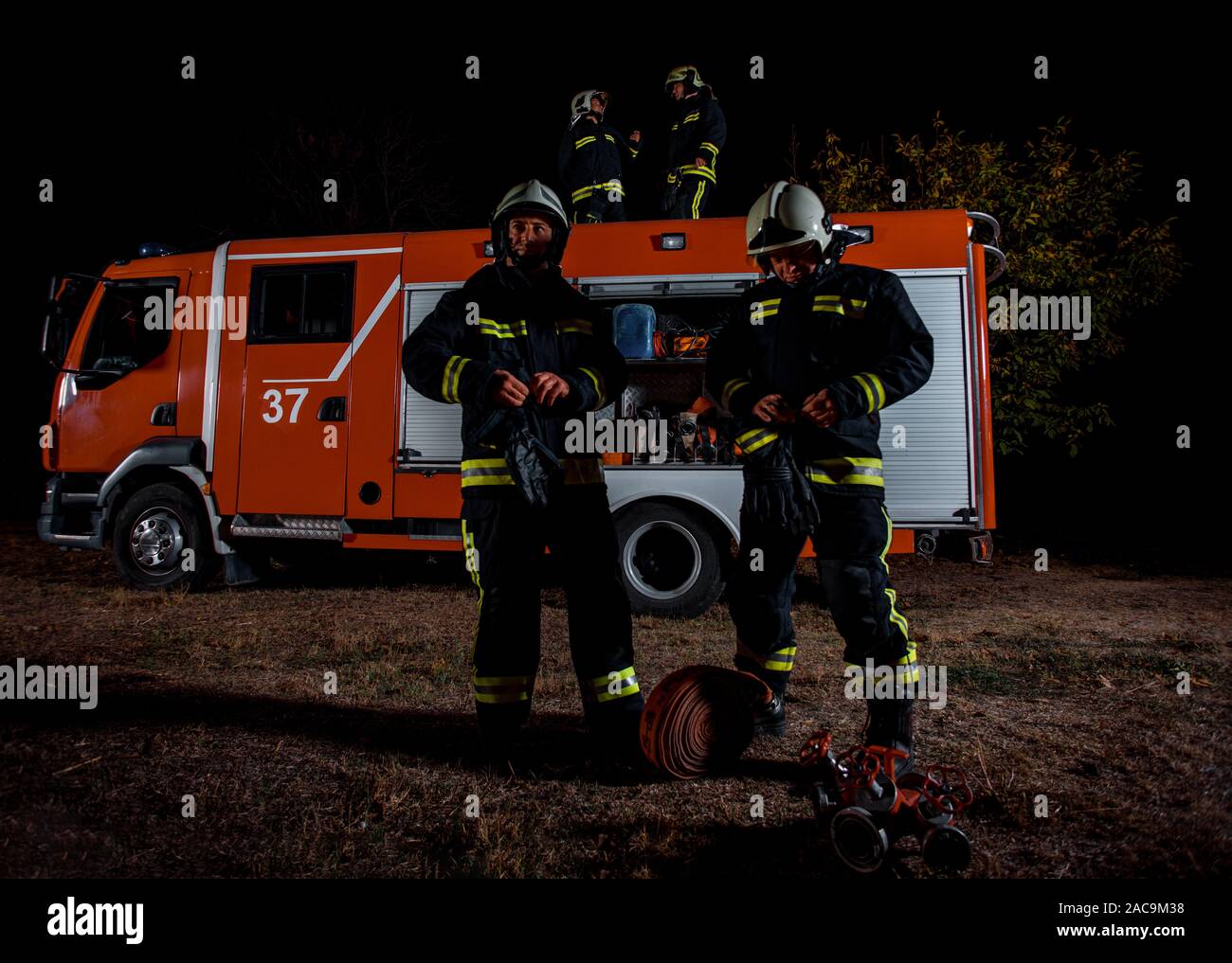Fire brigade during operation in the field at night time Stock Photo ...