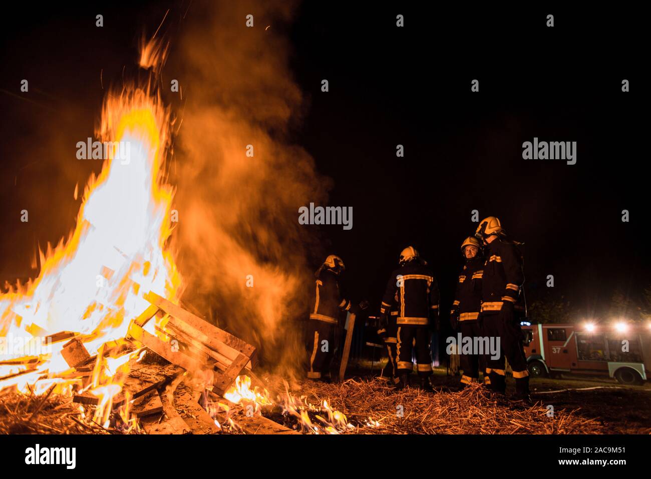 Fire brigade during operation in the field at night time Stock Photo ...