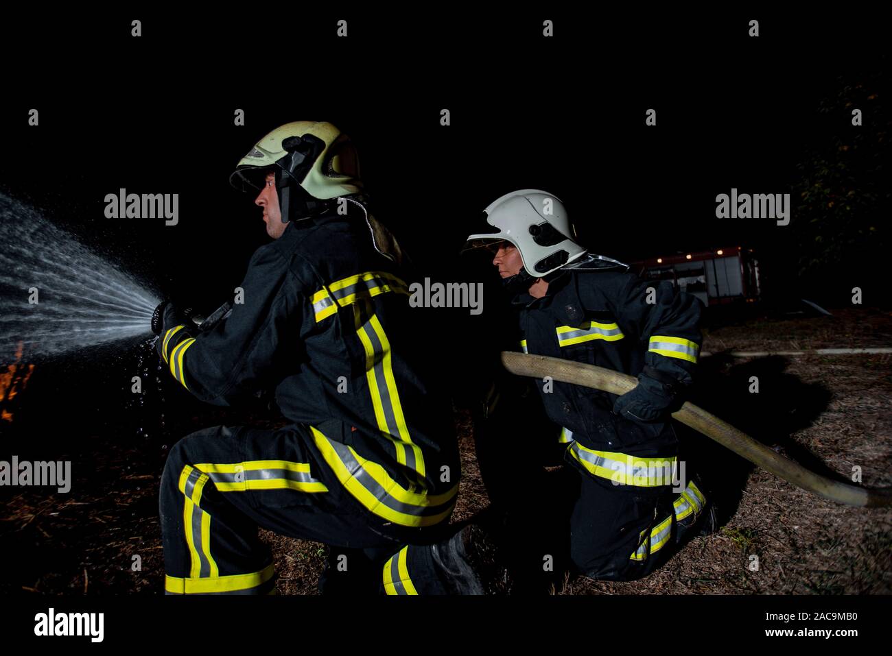Firemen wearing protective gear during a firefighting intervention ...