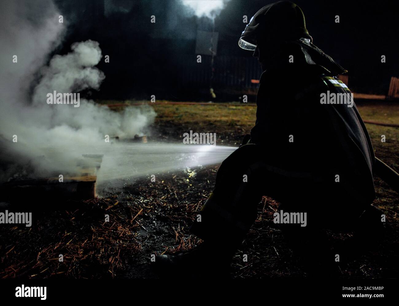 Fire brigade during operation in the field at night time Stock Photo ...