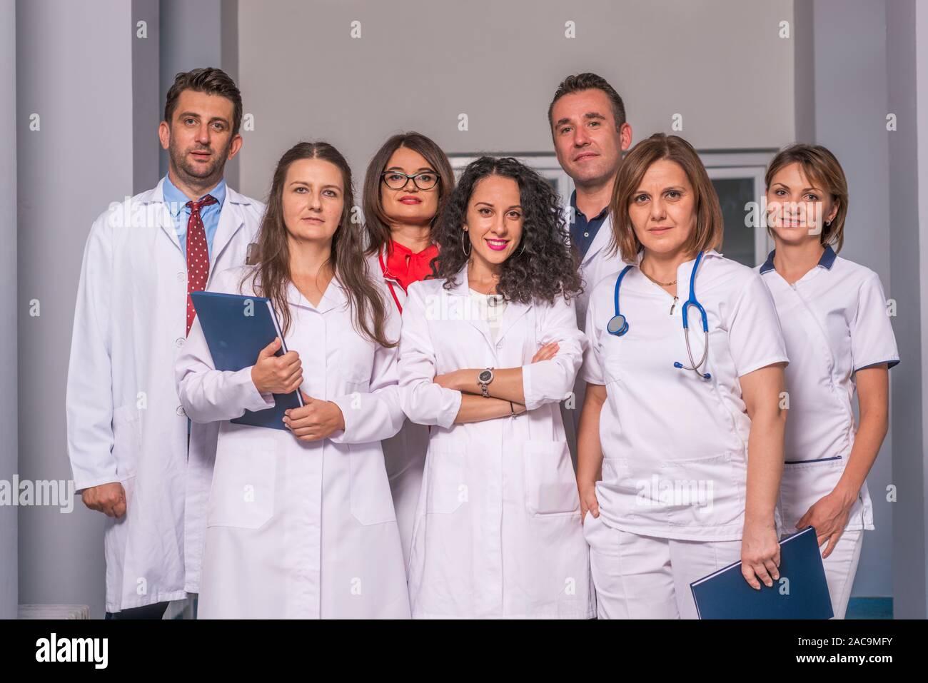 Group of medical staff, team doctors and nurses posing in the hallway ...