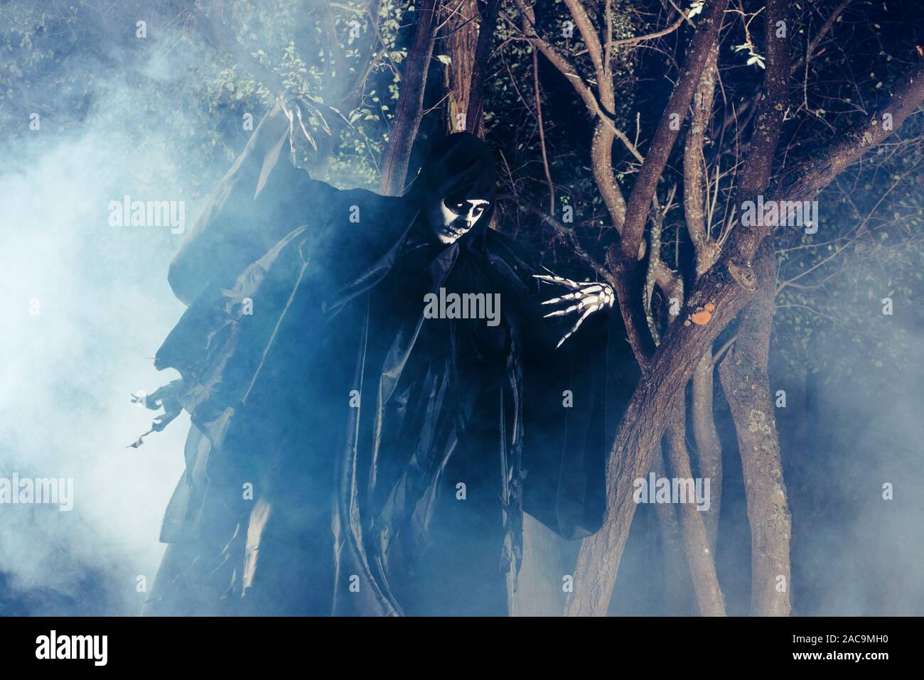 Portrait of the angel of death, grim reaper while standing in a ...