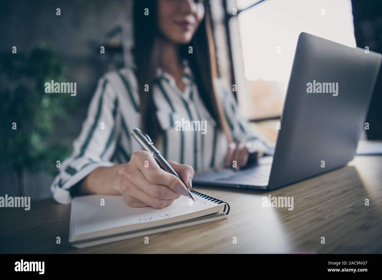Cropped close up photo of woman writing down necessary information ...