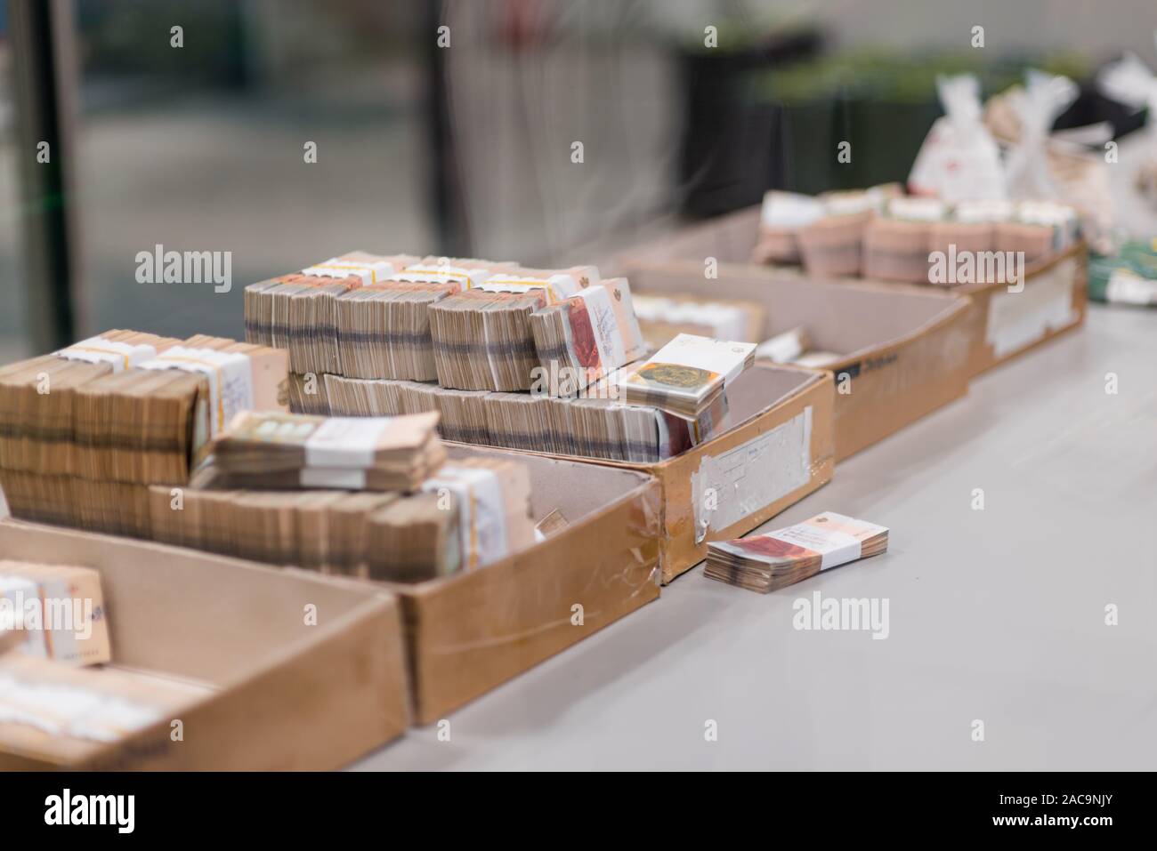Carton boxes full of various types of binded banknotes with bill straps ...