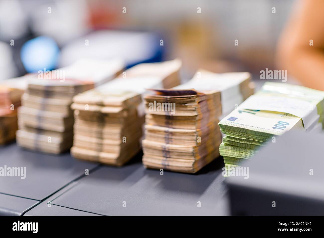 Bundles of different types of cash divided with currency bands and ...