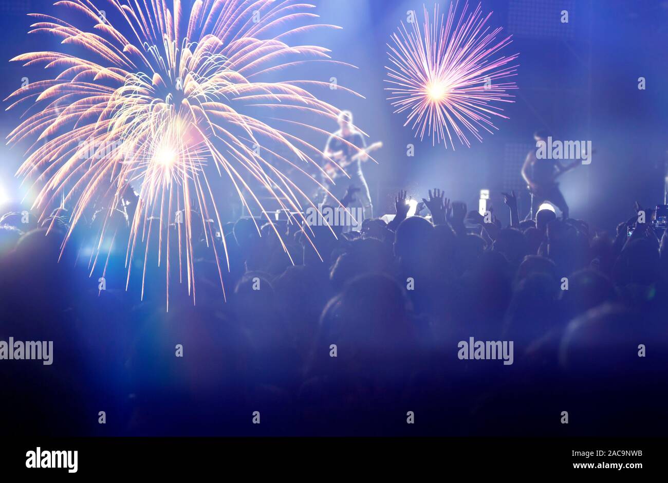 New Year concept - fireworks and cheering crowd celebrating the New ...