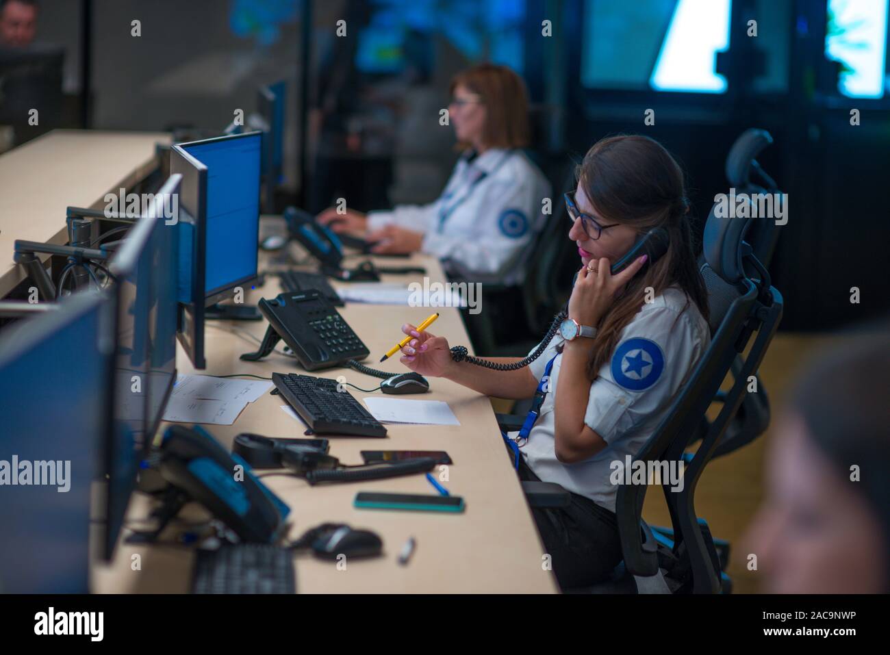 Security guard monitoring modern CCTV cameras in a surveillance room ...