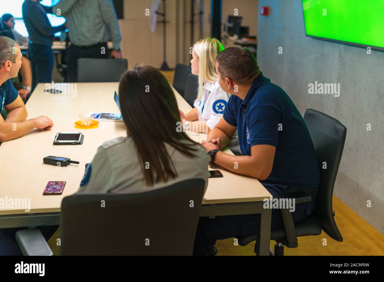 Security guard monitoring modern CCTV cameras in a surveillance room ...