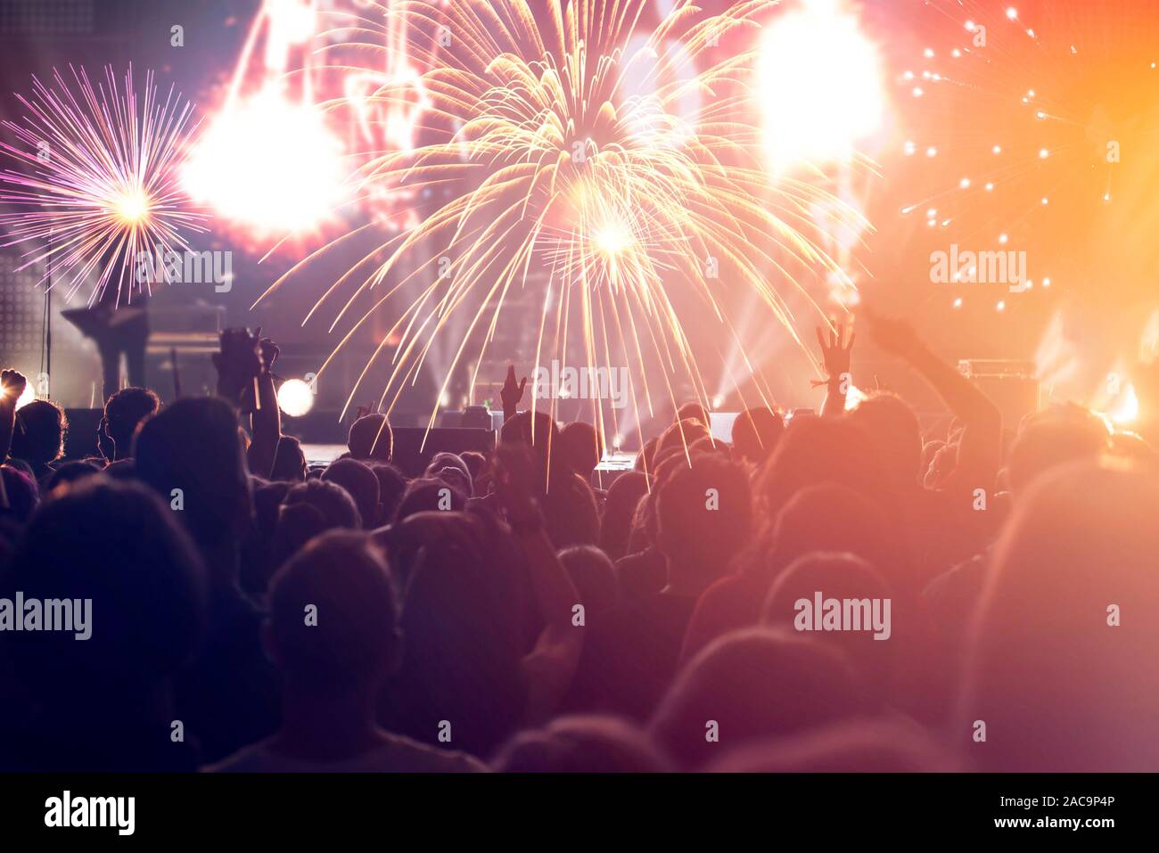 New Year concept - fireworks and cheering crowd celebrating the New ...