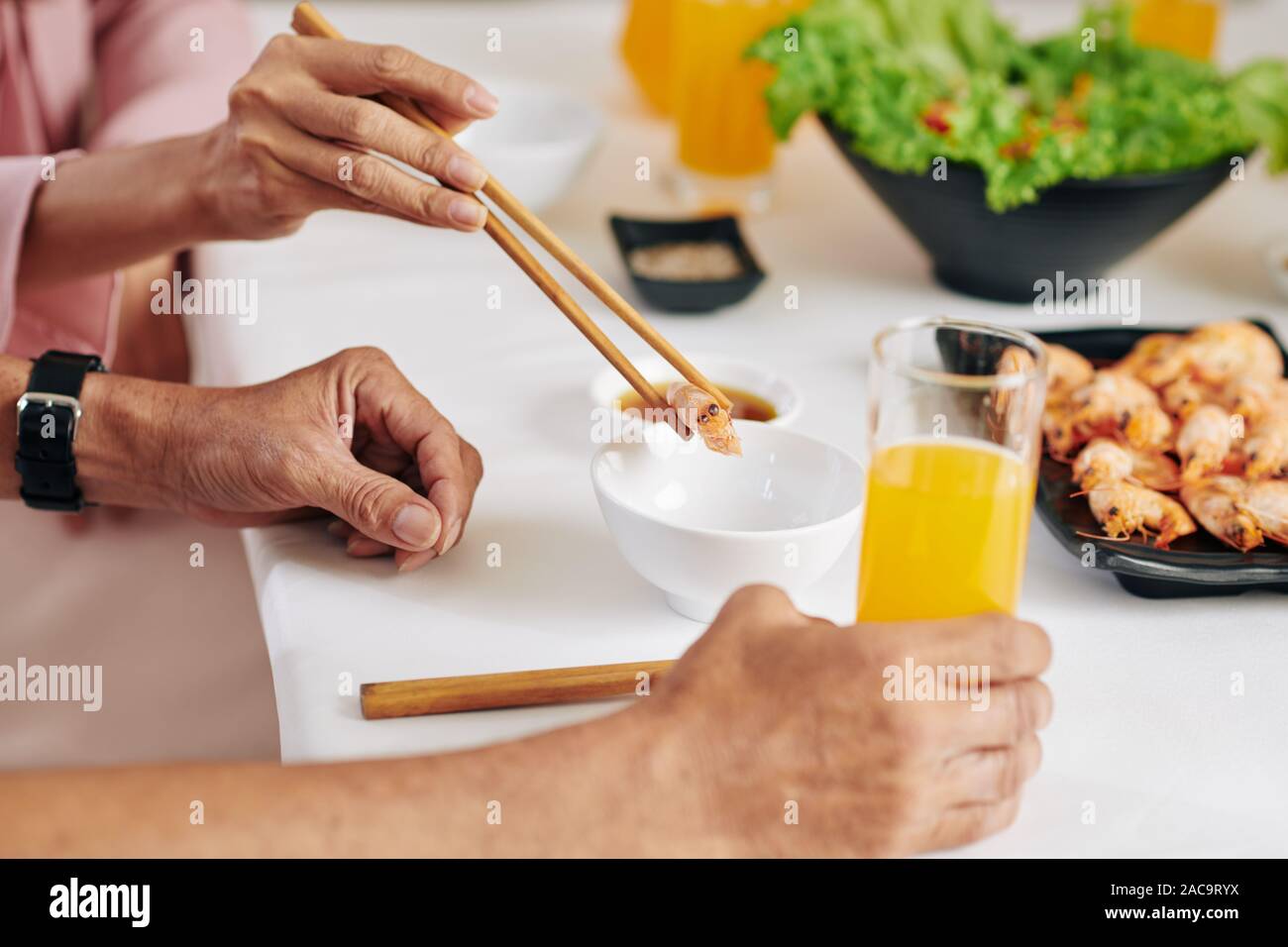 Young woman cooking shrimp in hi-res stock photography and images - Alamy