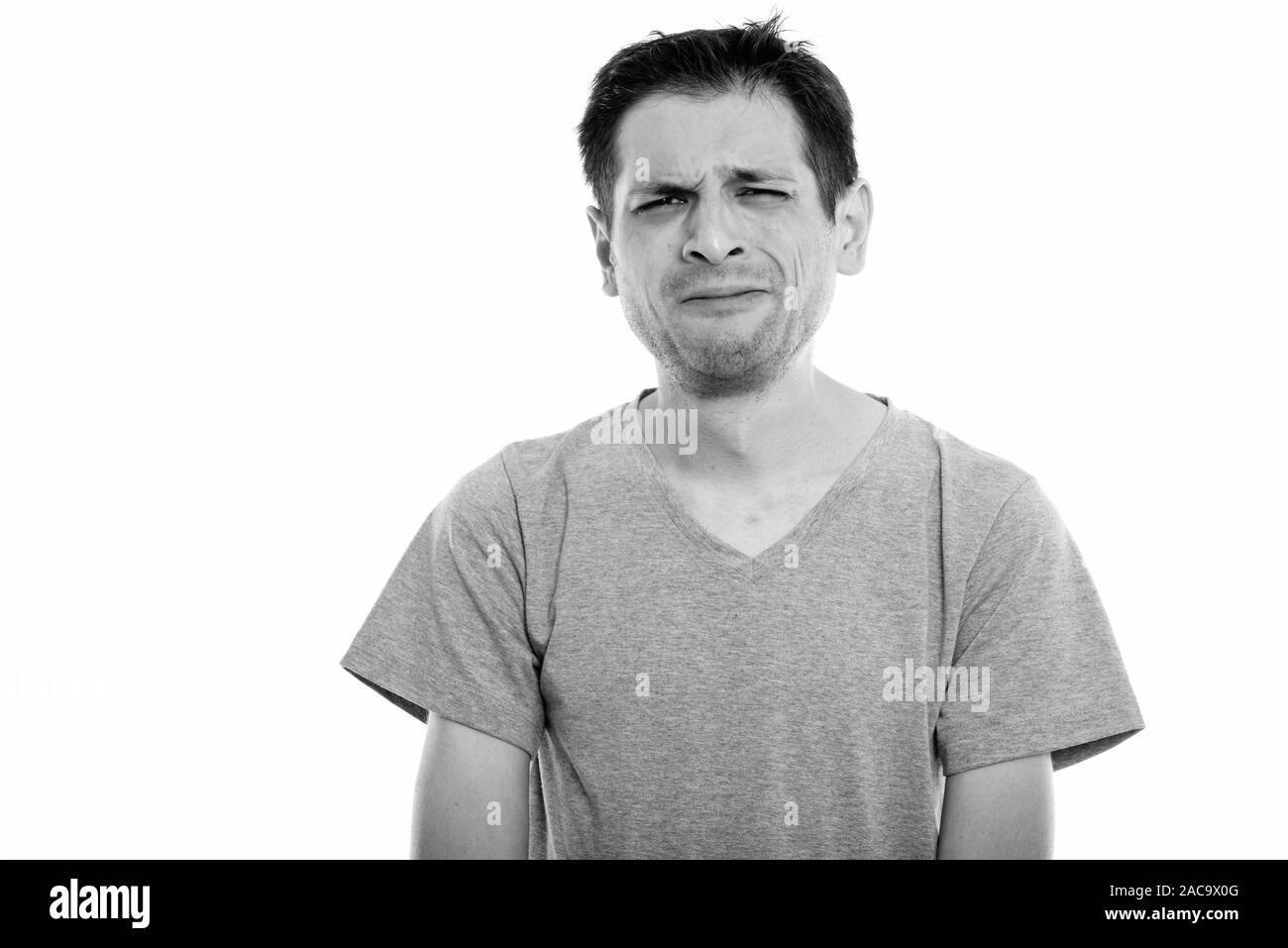 Studio shot of young man looking sad Stock Photo - Alamy