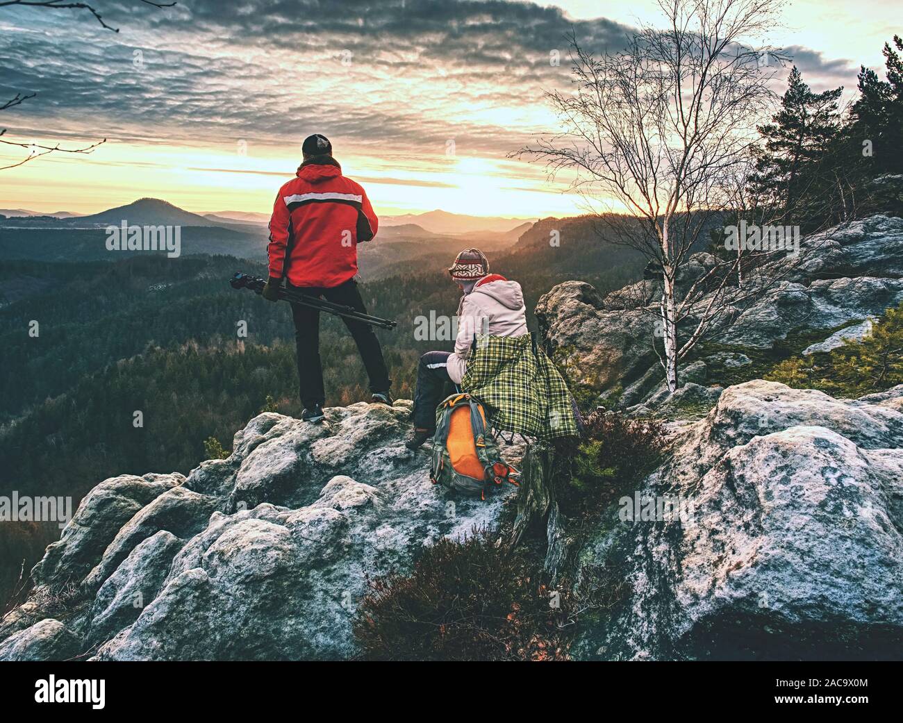 Two photographers with camera and tripod stay along the path in ...
