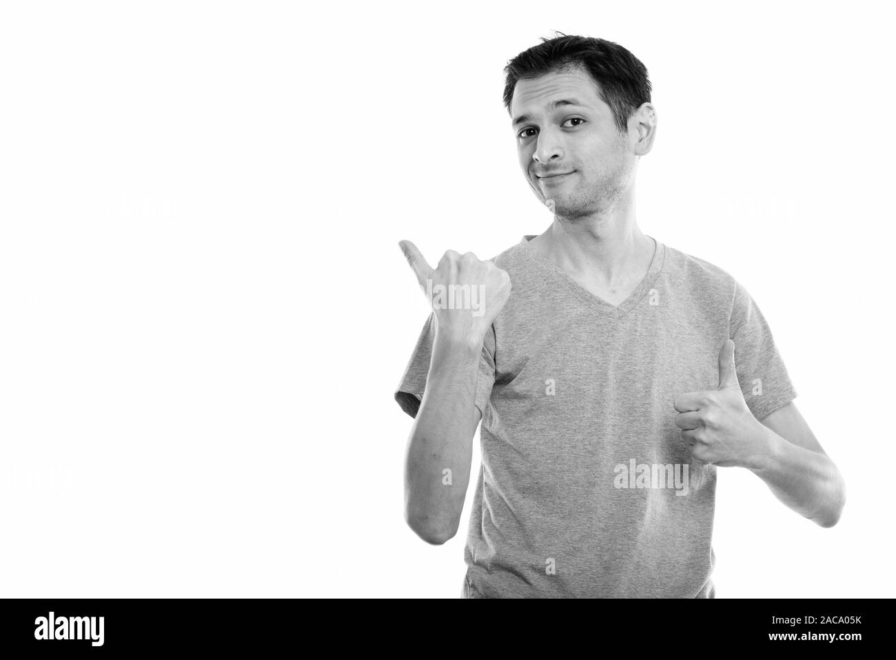 Studio shot of young man giving thumbs up Stock Photo - Alamy