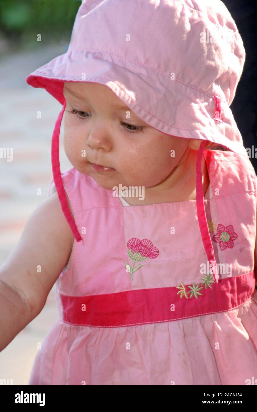 Girl with pink bonnet hi-res stock photography and images - Alamy