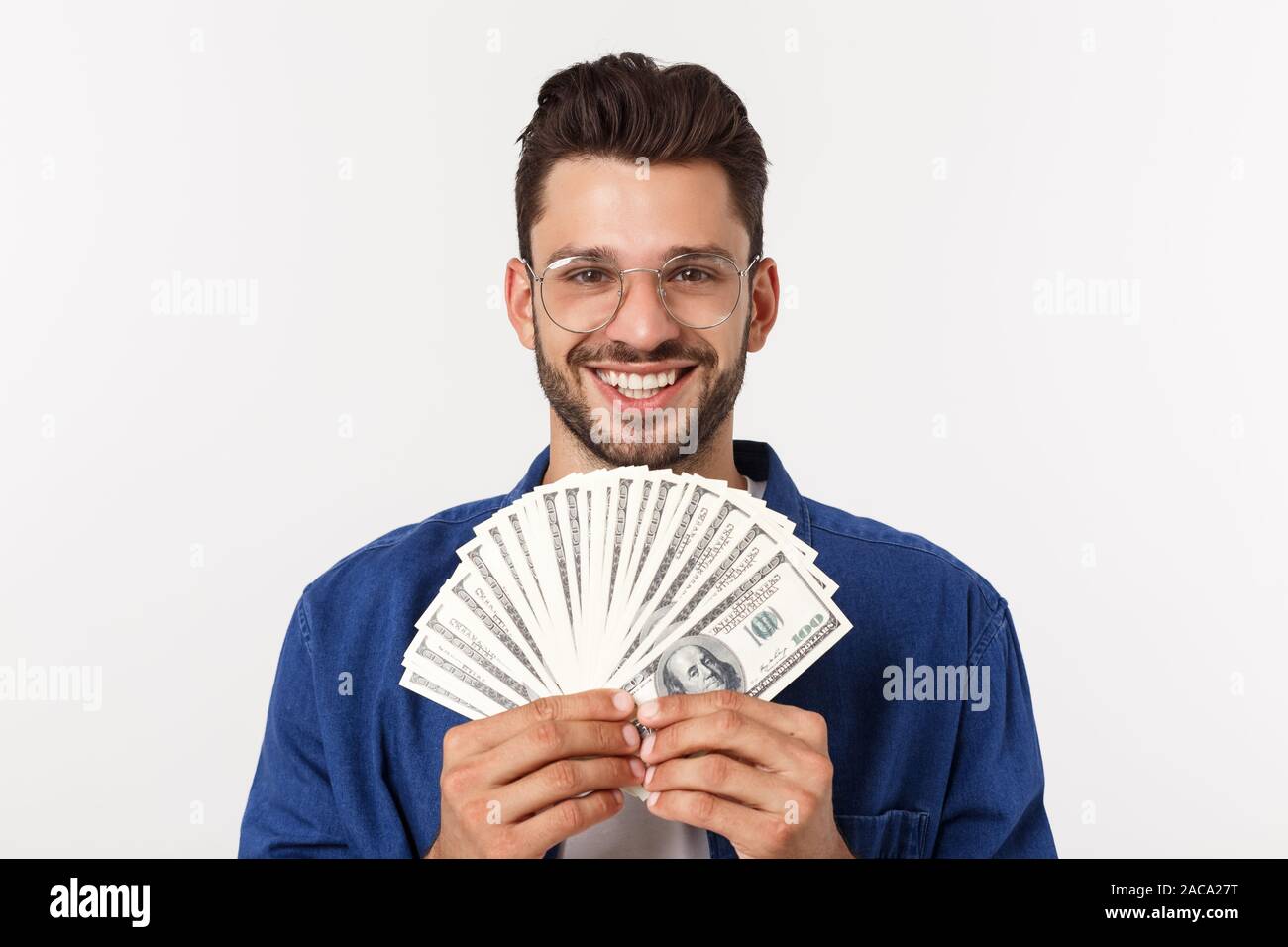 Attractive man is holding cash money in one hand, on isolated white ...